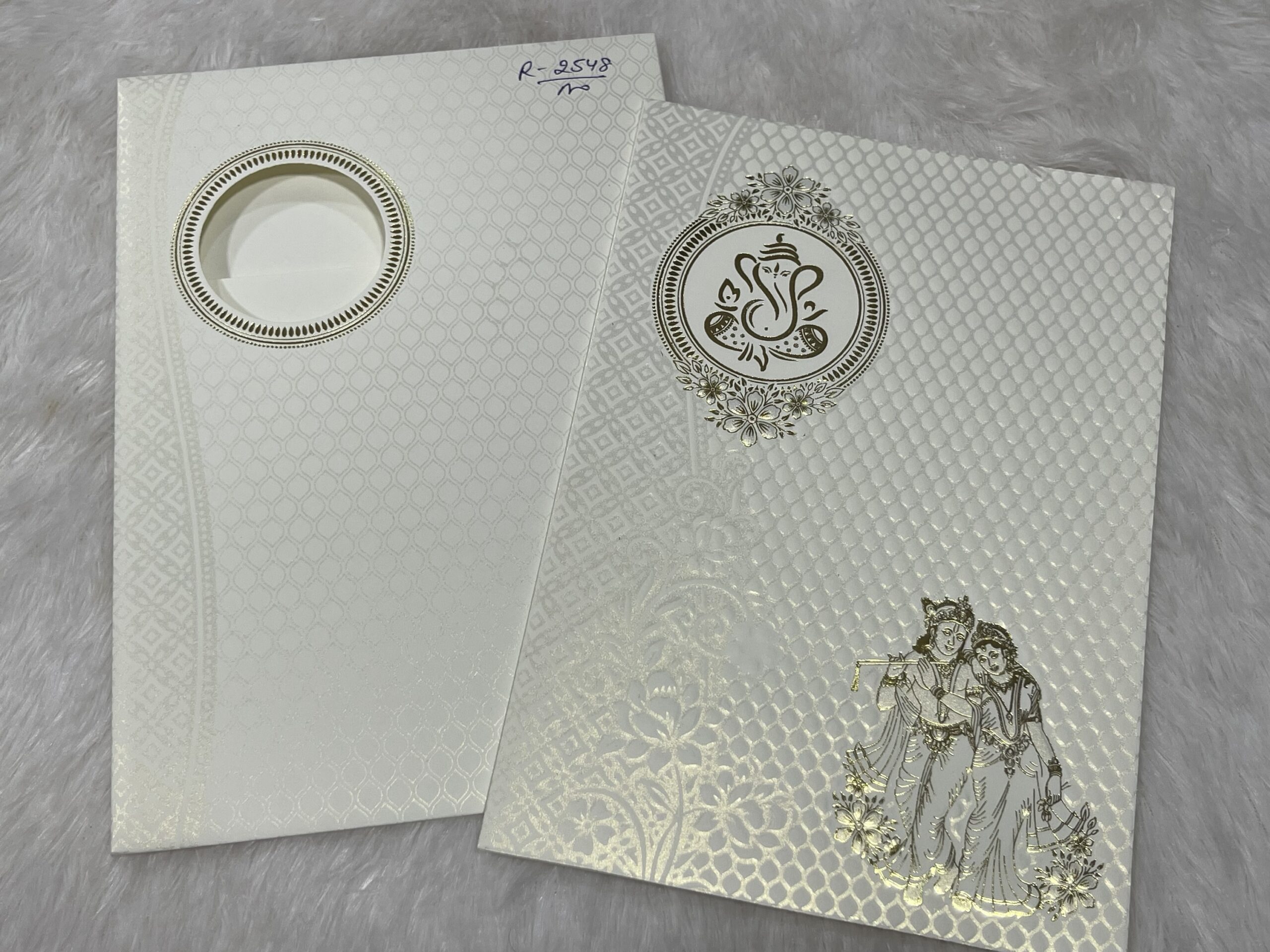 Folder style wedding invitation card with Ganesh and radhakrishna along ...